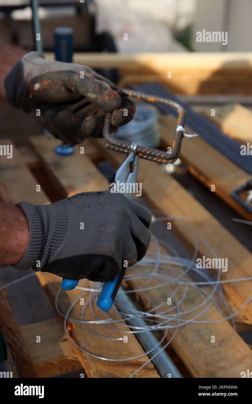 Close up photo of man holding pliers. Man works with reinforcement ...