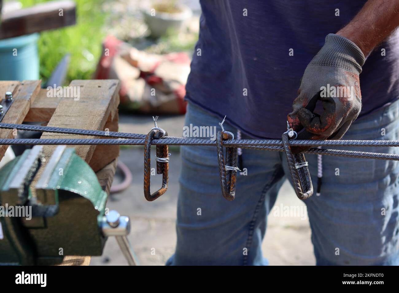 Close up photo of man holding pliers. Man works with reinforcement ...