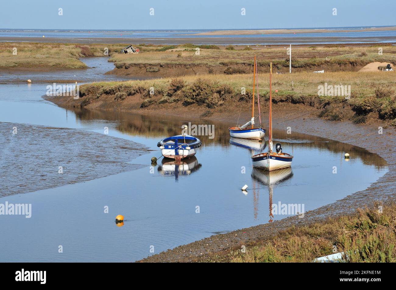 Boats moored on the coastal inlets and marshes between Morston and ...