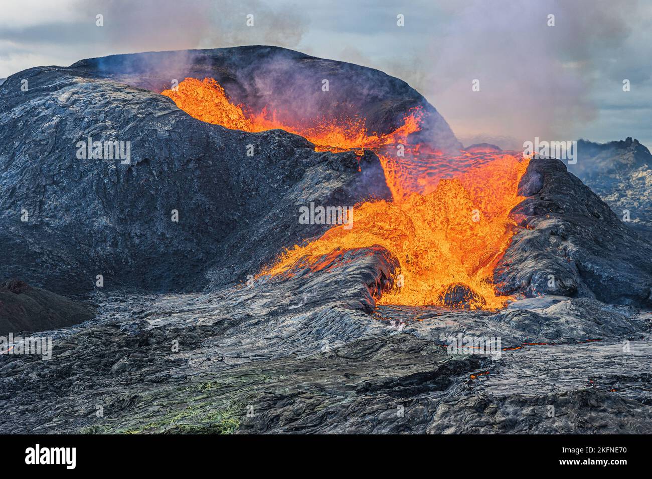 Active volcano about to erupt. strong lava flow from crater opening ...