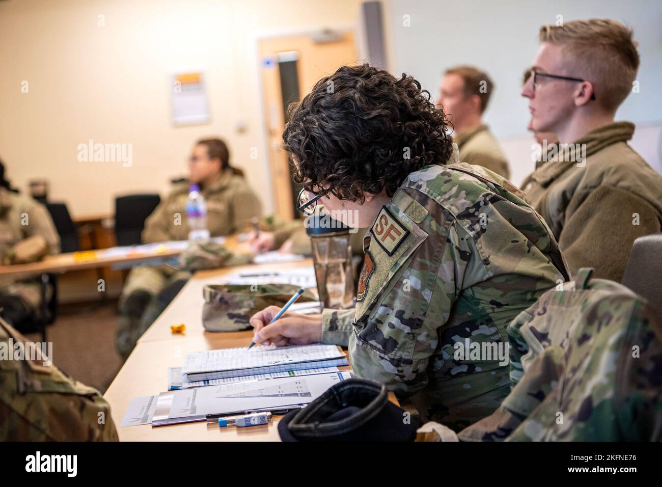 An Airman from the 423d Security Forces Squadron takes notes during ...