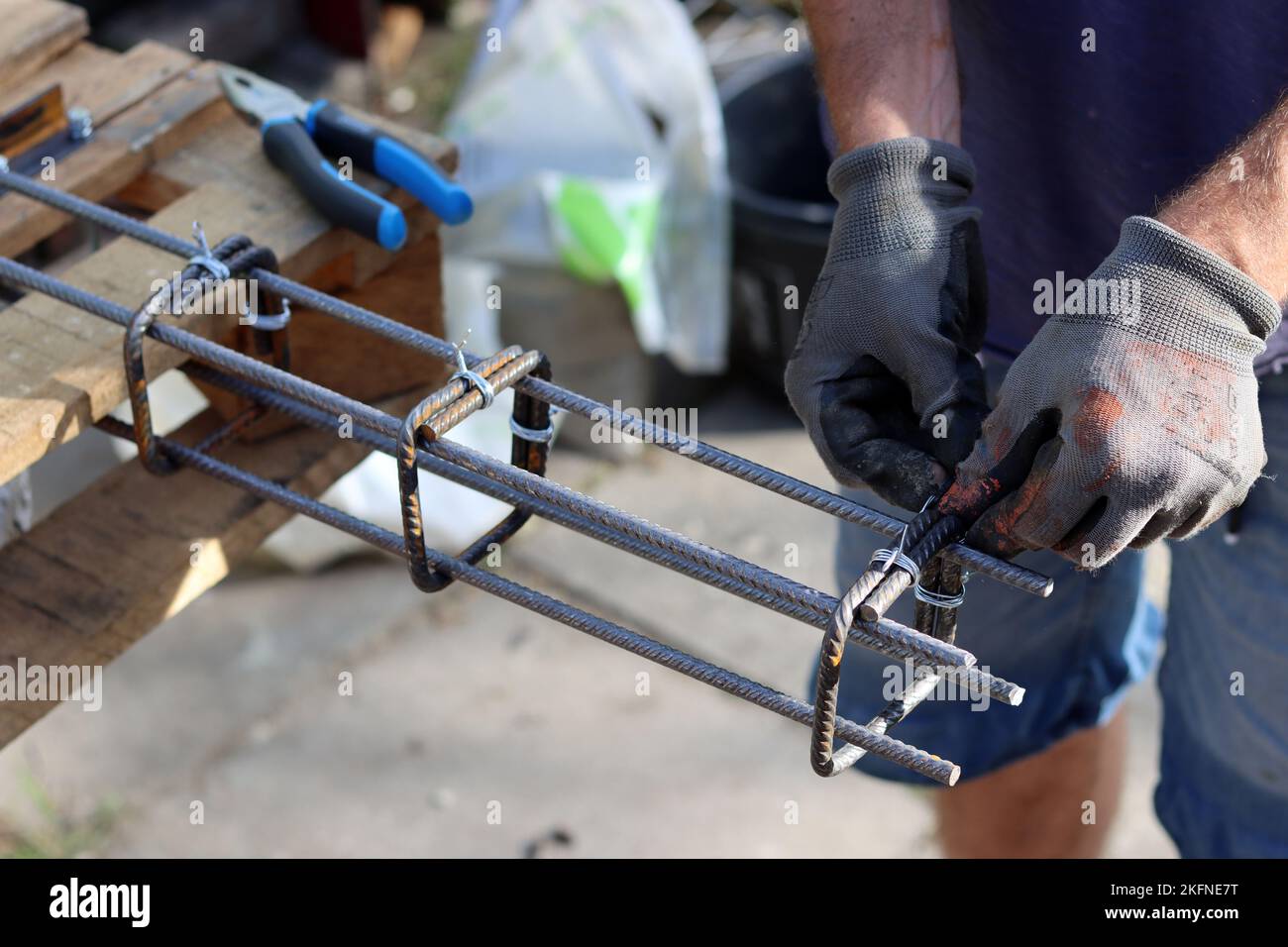 Close up photo of man holding pliers. Man works with reinforcement ...