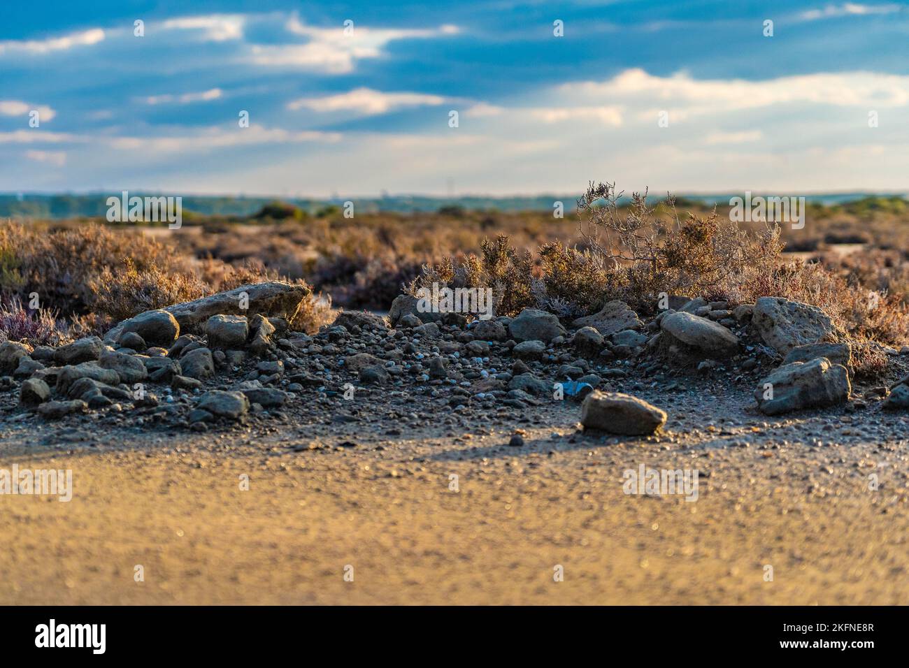 A Stony rocks and sands with clouds all over Stock Photo - Alamy