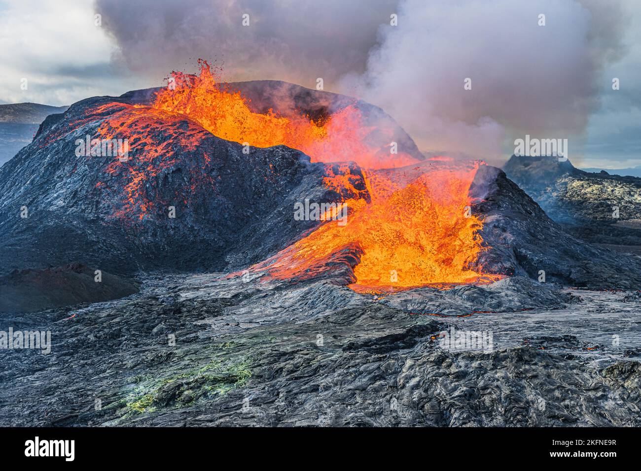 active volcano with strong lava flow. Volcano crater in iceland at time ...