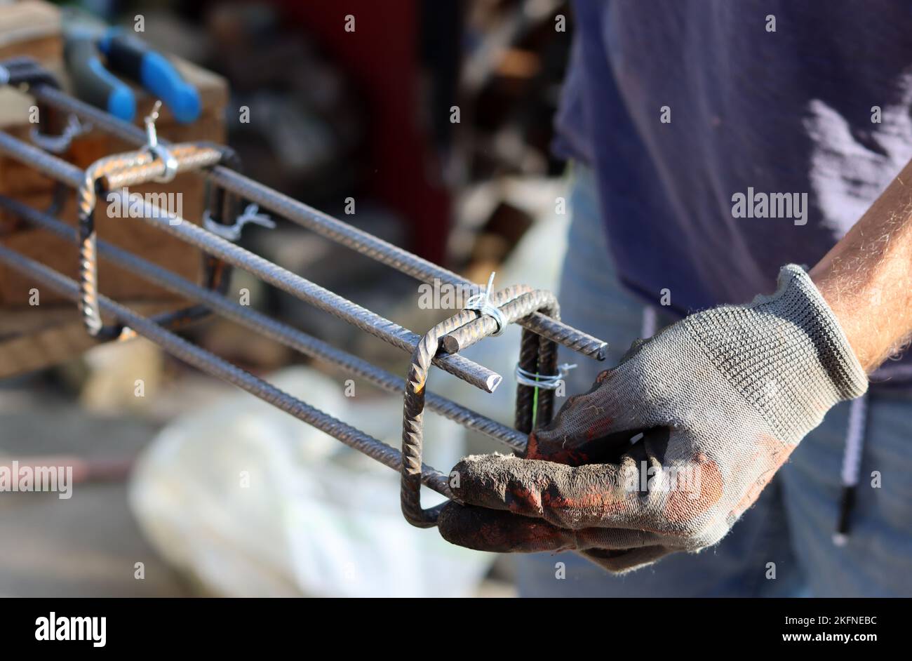 Close up photo of man holding pliers. Man works with reinforcement ...
