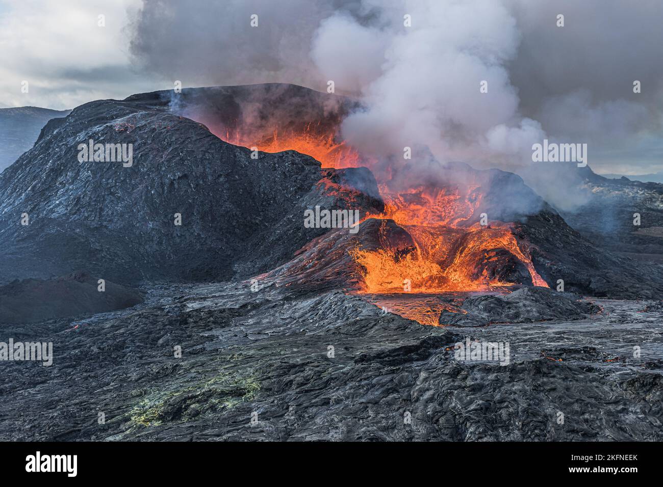 Volcano on Iceland after eruption. Hot steam clouds over crater opening ...