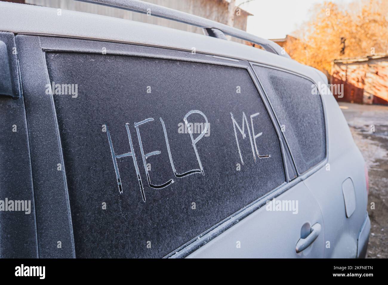 The text Help Me on the frozen glass of the car Stock Photo - Alamy