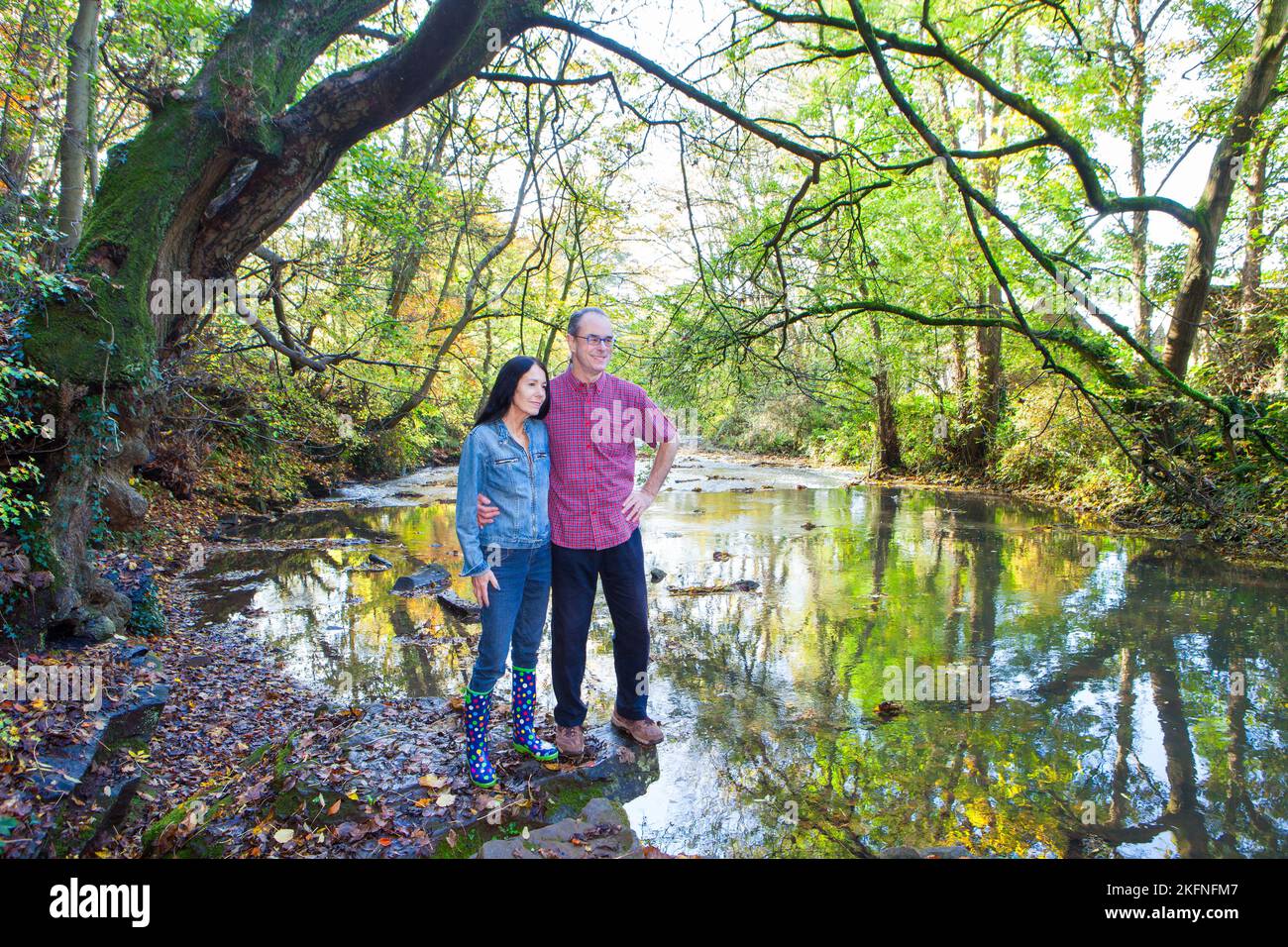 Couple standing in shallows of River Frome Stock Photo - Alamy
