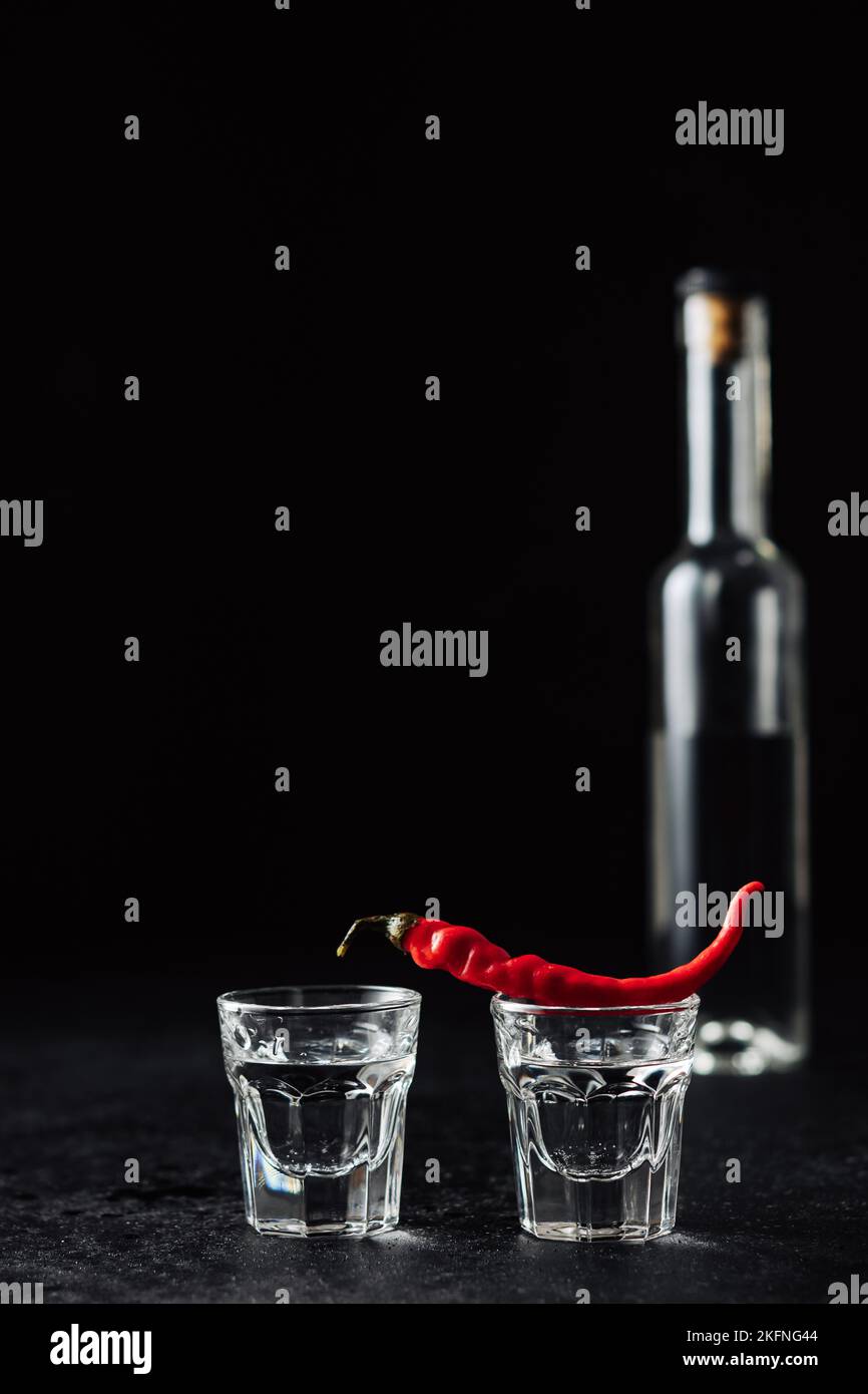 Two shots of vodka with red hot pepper Stock Photo - Alamy