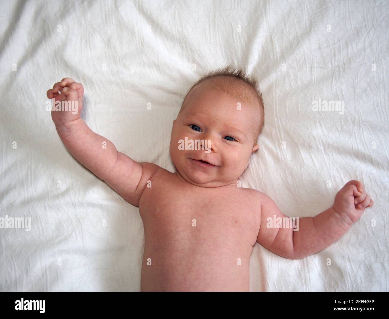 Smiling baby waving chubby arms Stock Photo - Alamy