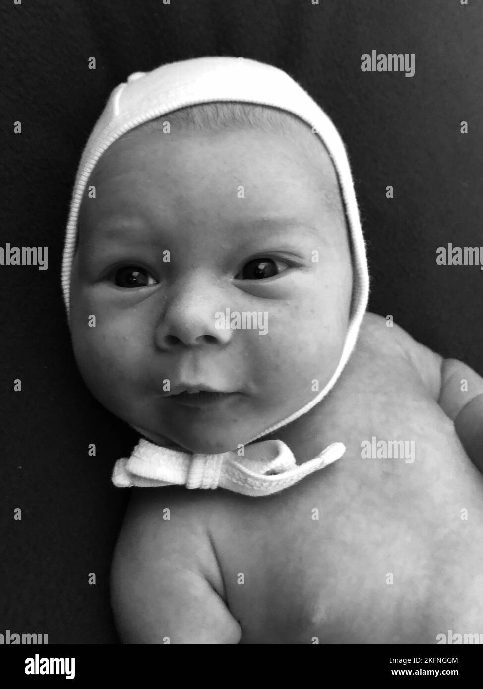 Black and white cute newborn baby in white hat Stock Photo - Alamy