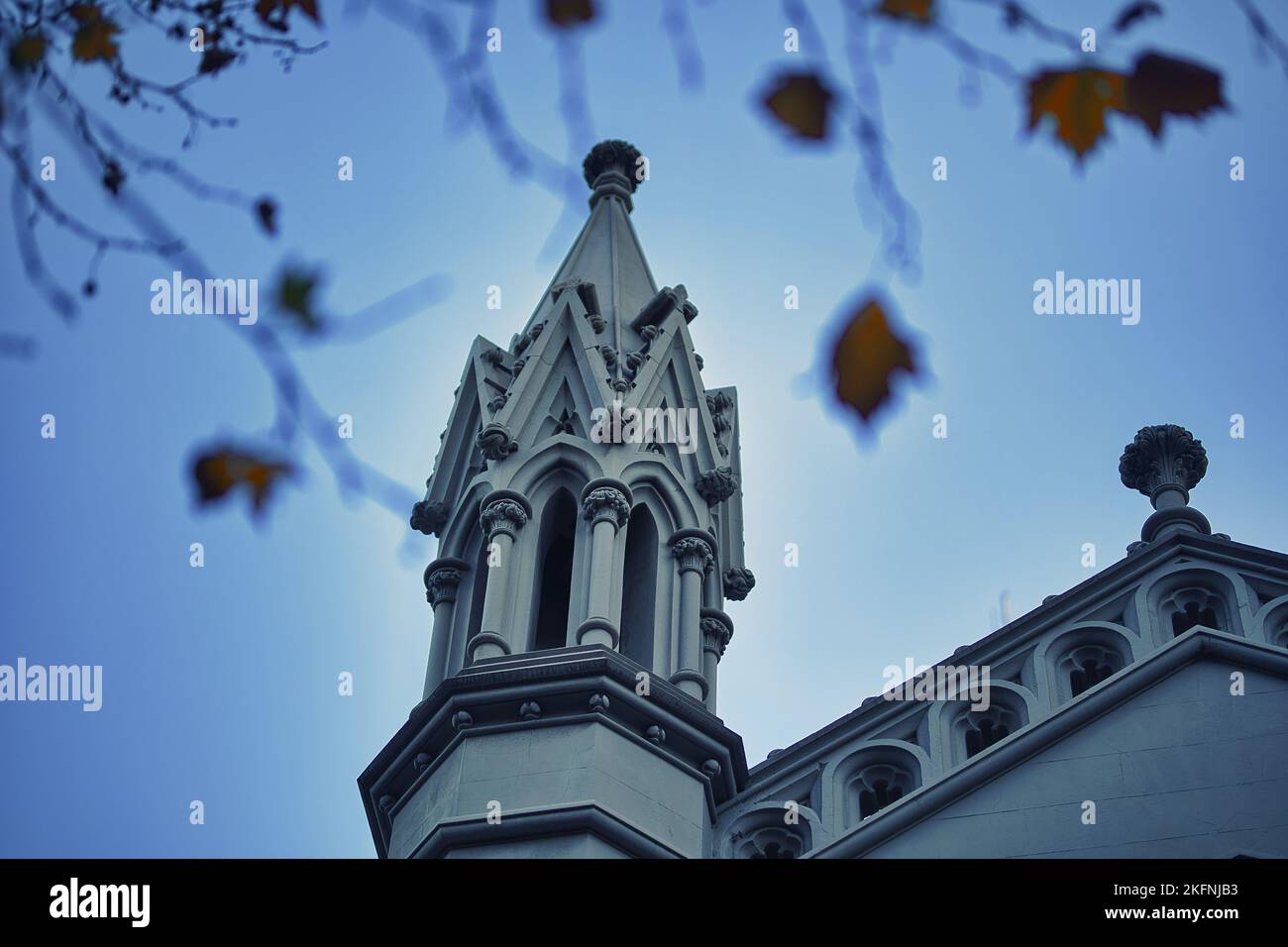 A low angle shot of old ornamental Cathedral tower under blue sky Stock ...