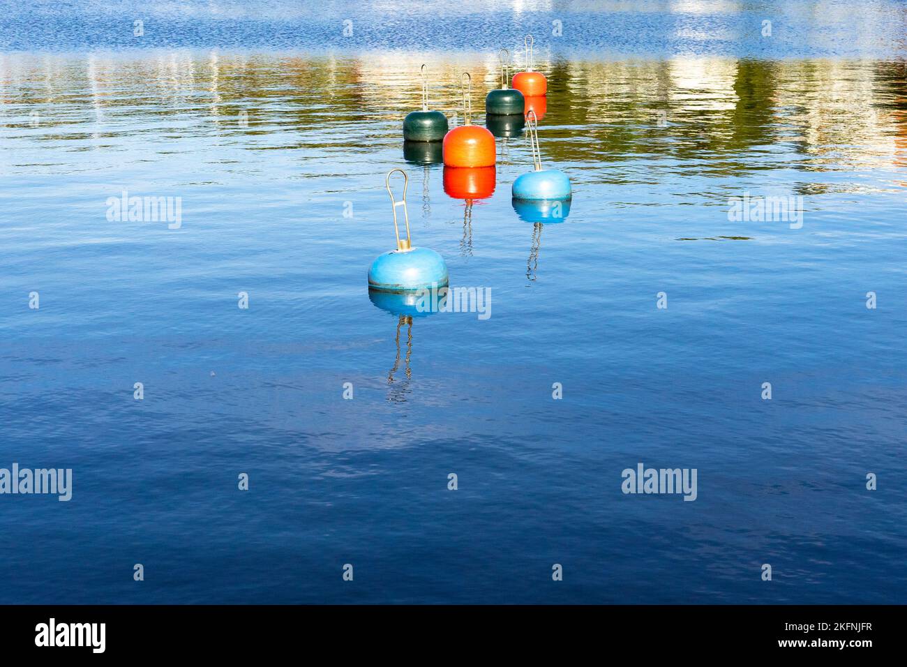 Red buoys on the sea waves background Stock Photo - Alamy