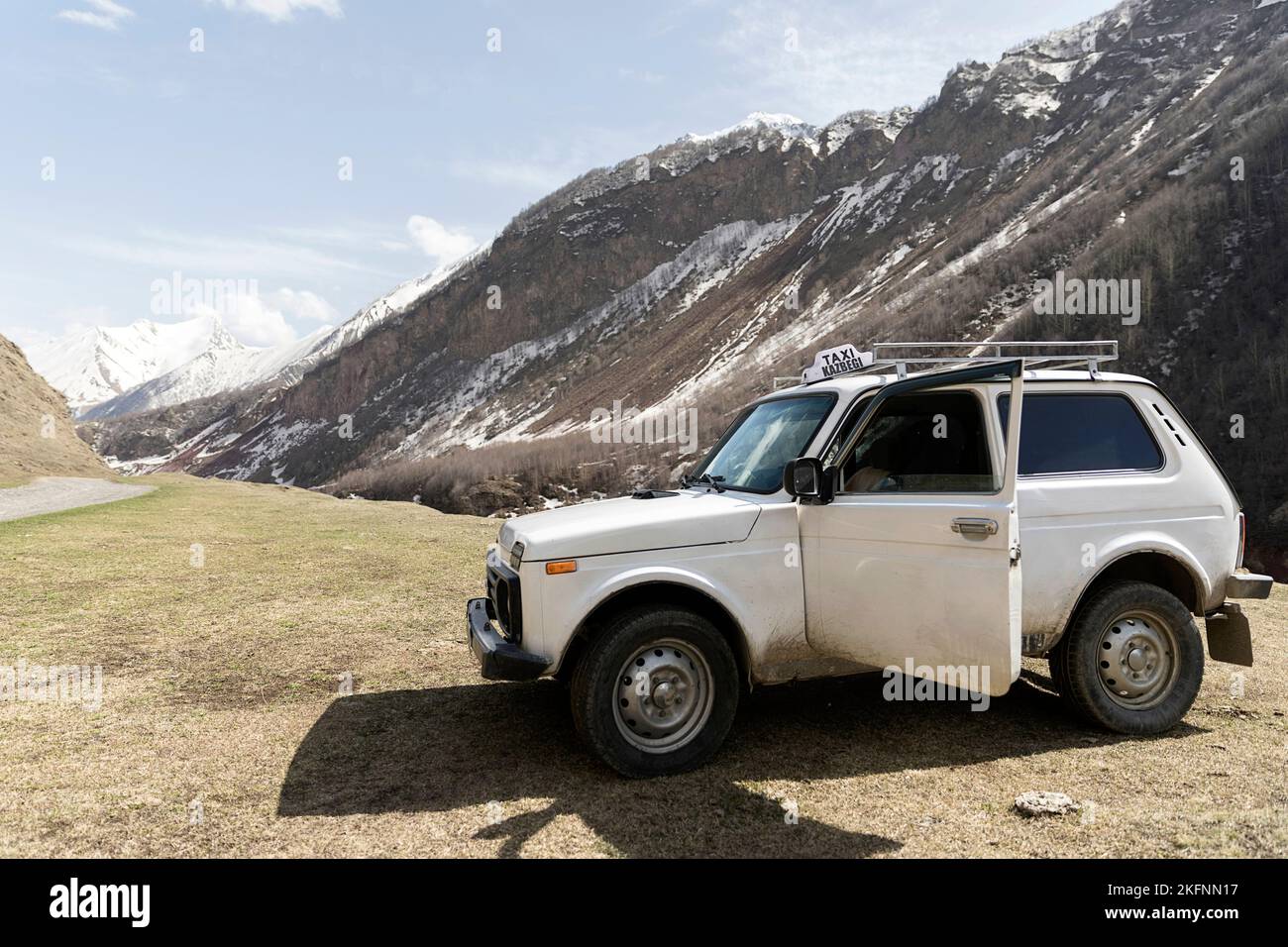 Local taxi car Lada Niva waiting for tourist at the end of truso valley ...