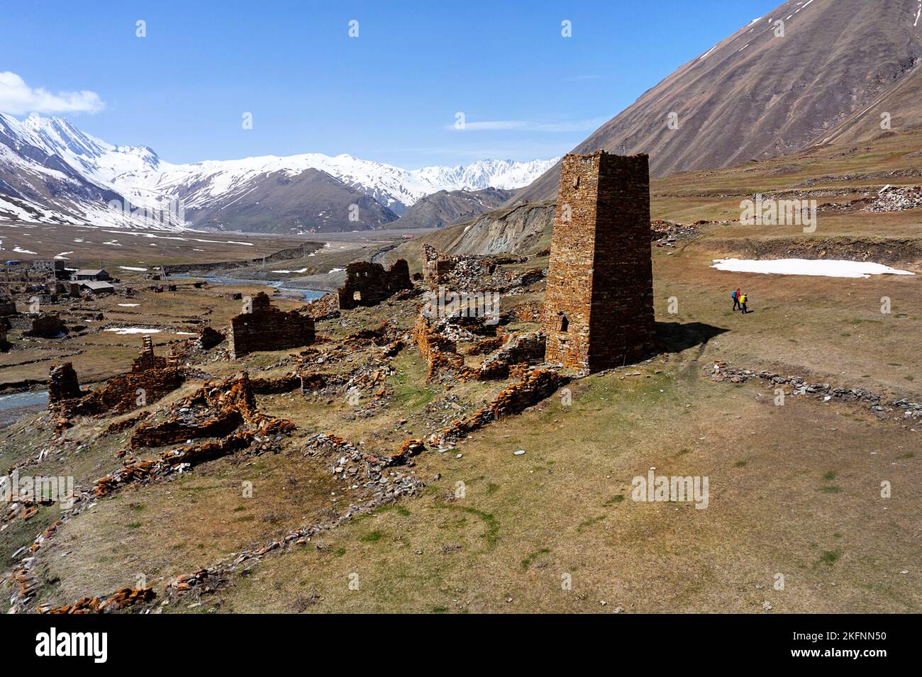 Hikers near Ketrisi Former Tower in beautiful Truso valley in caucasus ...