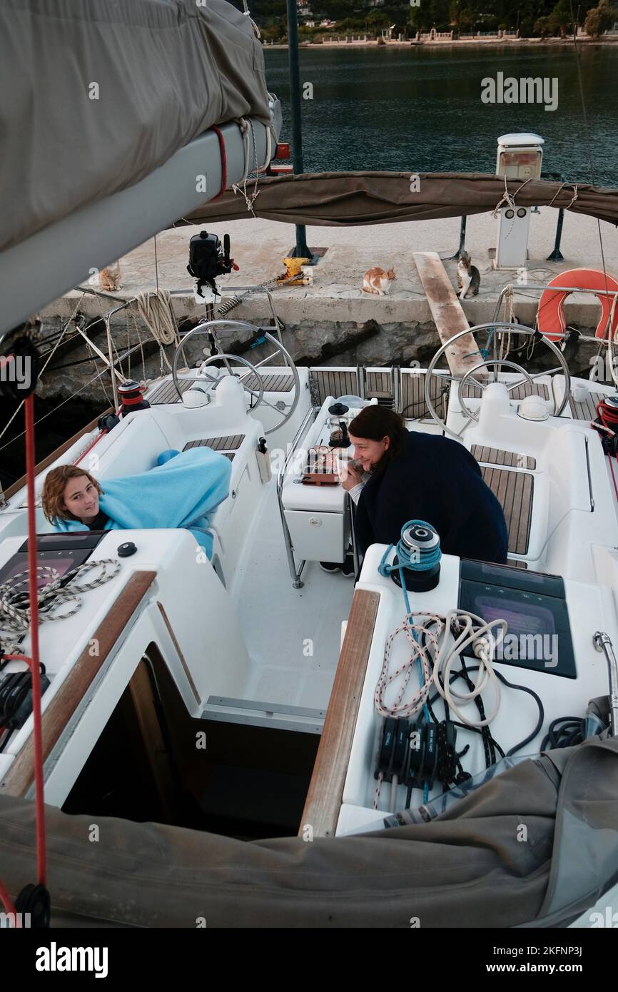 Relaxing in the cockpit of a sailing yacht in port Stock Photo - Alamy