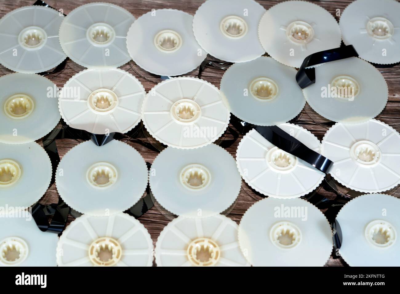 Stack of supply and take up reels with ribbon of VHS video cassette ...