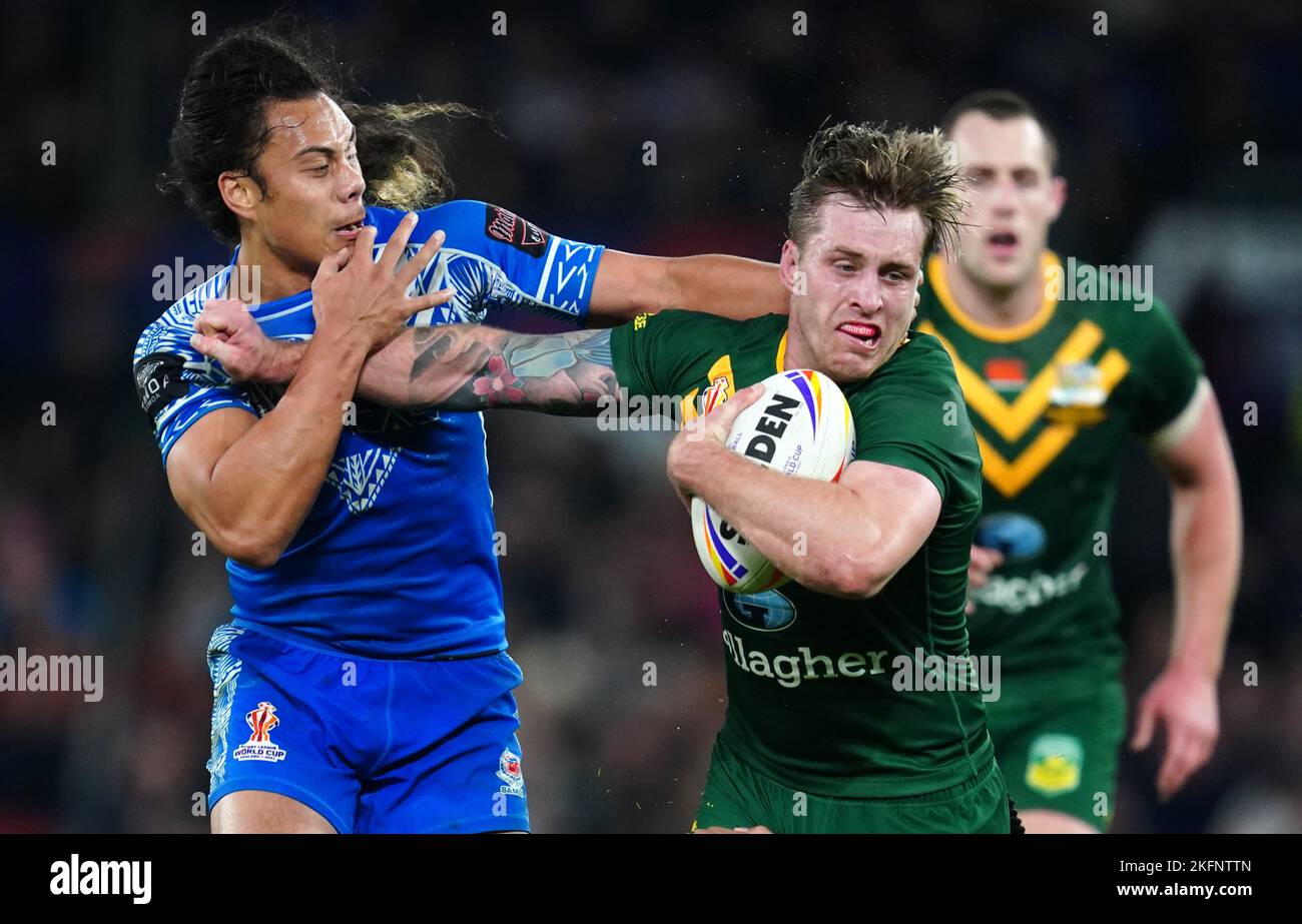 Australia's Cameron Munster (centre) holds off Samoa's Jarome Luai ...