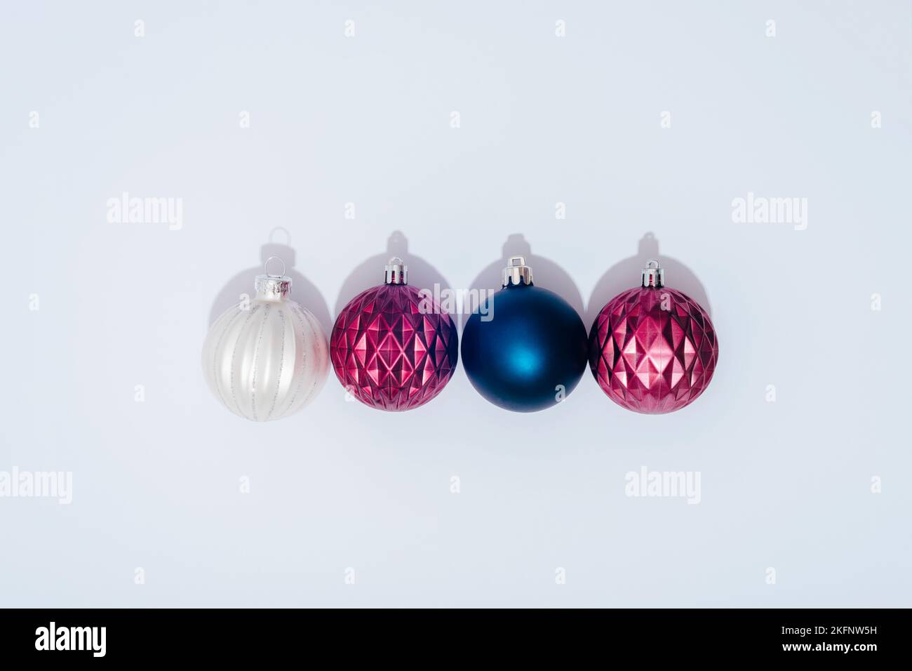 Colorful Christmas balls on white background with sharp shadows. Top ...