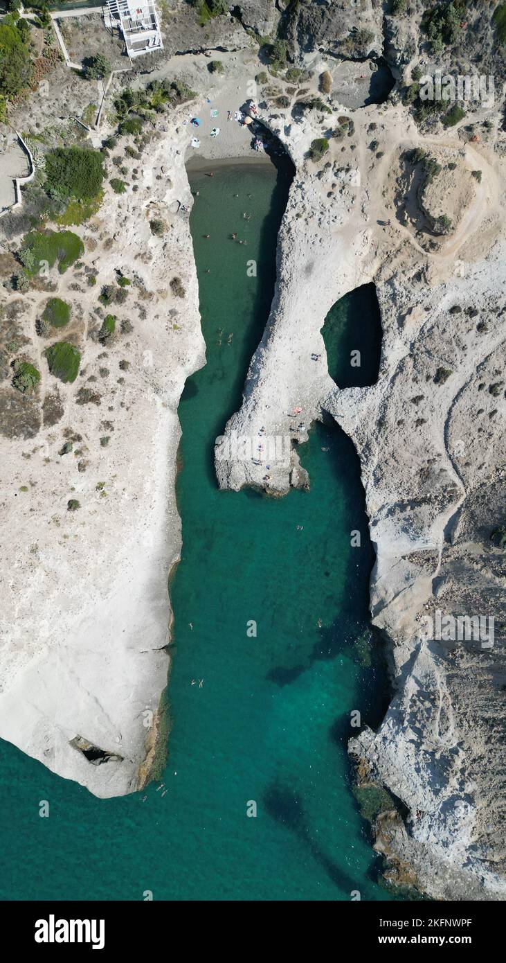 An aerial view of a white rocky coast on an island meeting a crystal ...