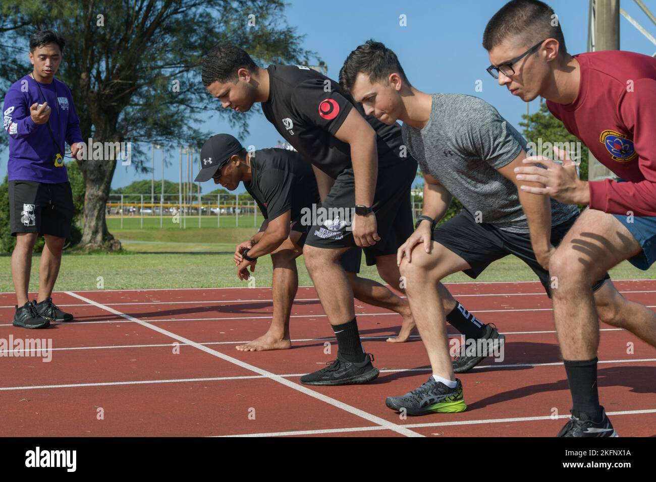 Airmen line up at the start of a relay race at Kadena Air Base, Japan ...