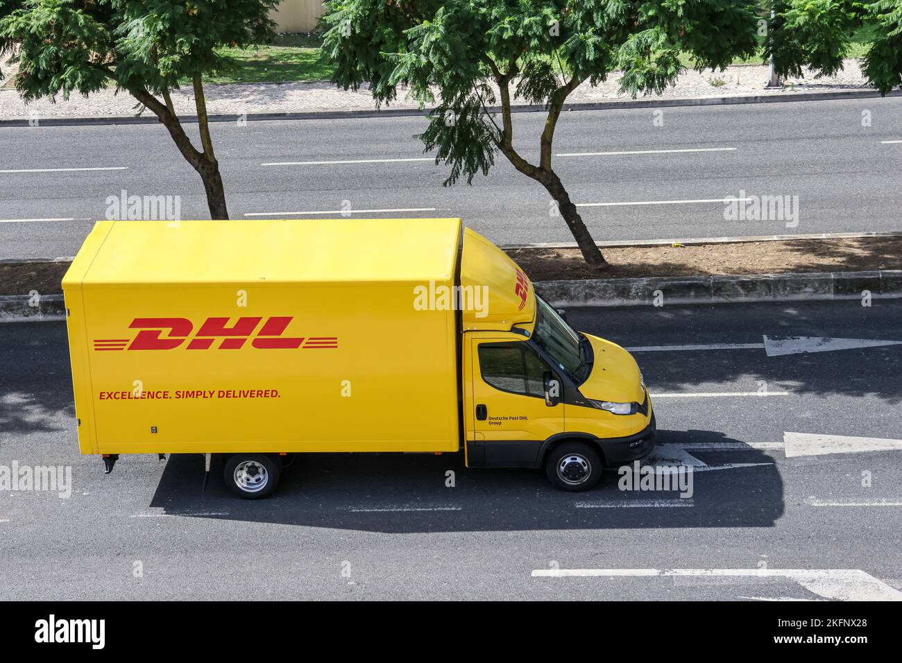 A yellow DHL delivery truck in the street Stock Photo - Alamy