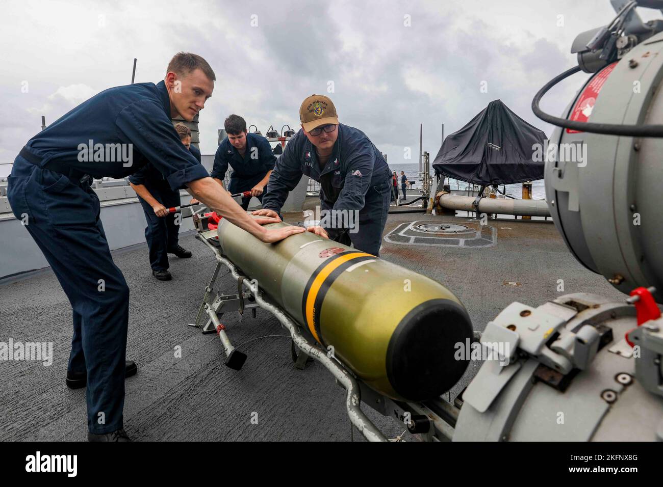 SOUTH CHINA SEA (Sept. 29, 2022) Sailors load an MK46 torpedo after ...
