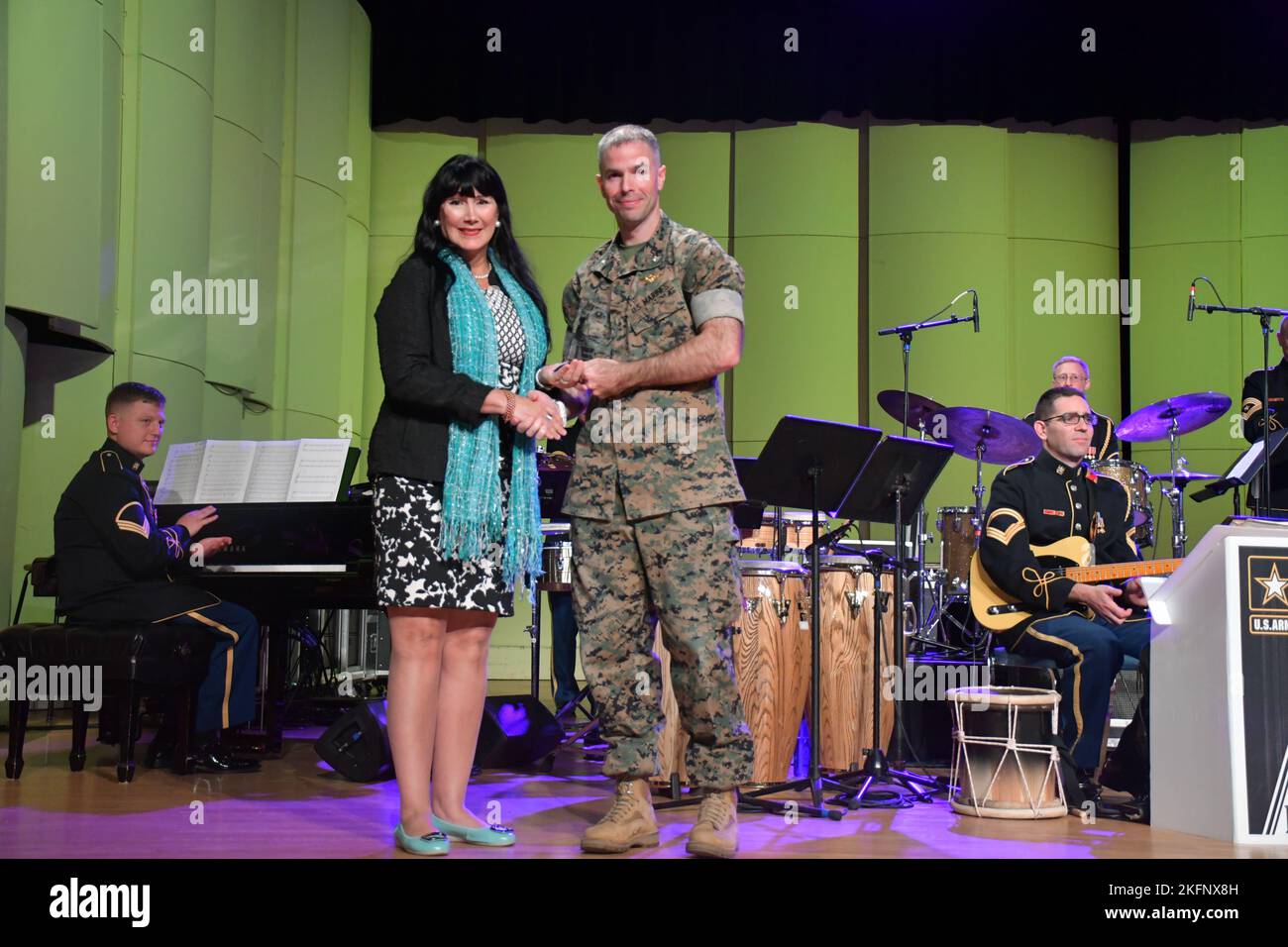 Lt. Col. John Dexter presents a plaque to Retired Birg. Gen. Dr. Irene ...