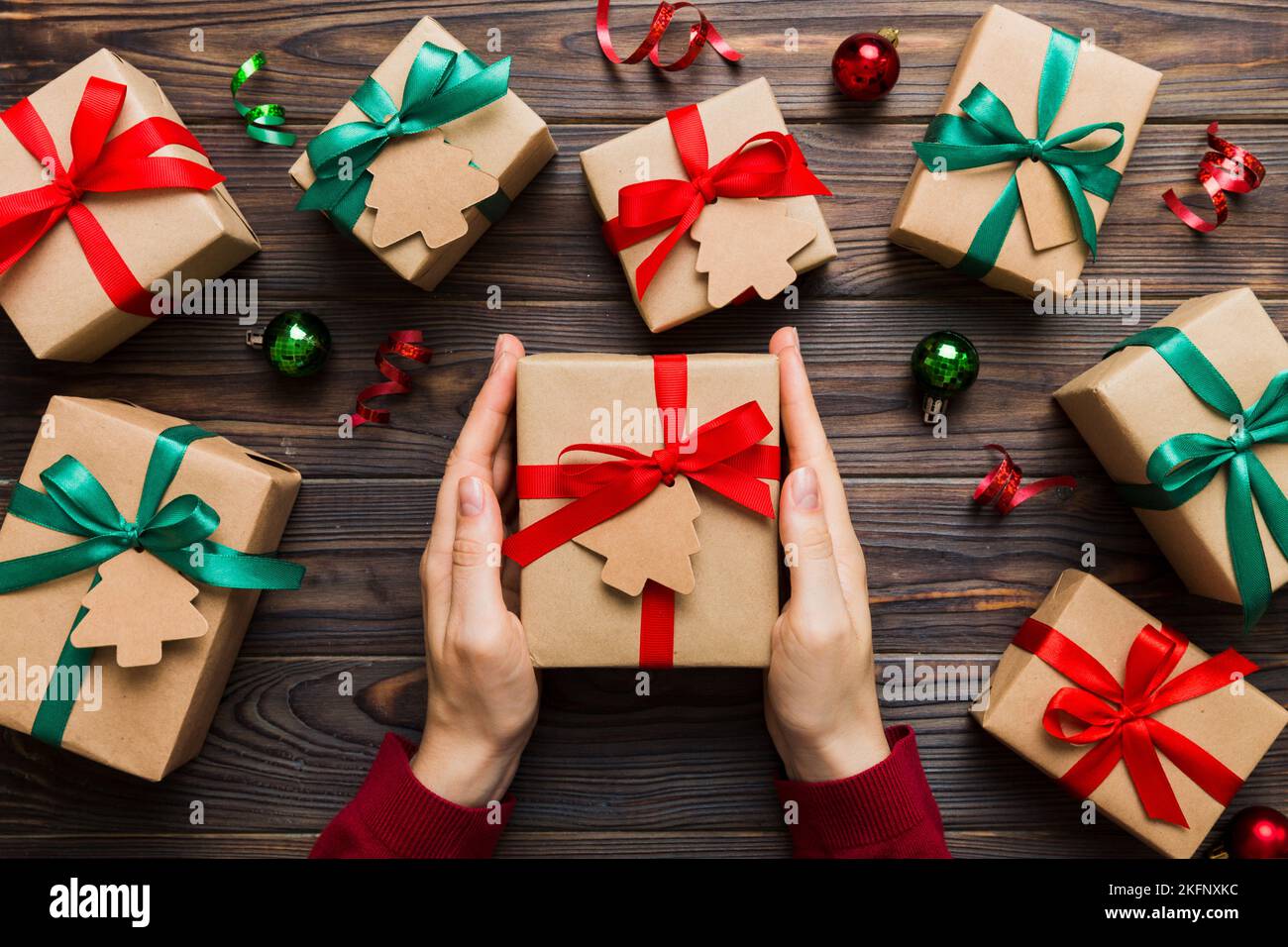Woman hands holding gift box, preparing surprise for holiday, top view ...