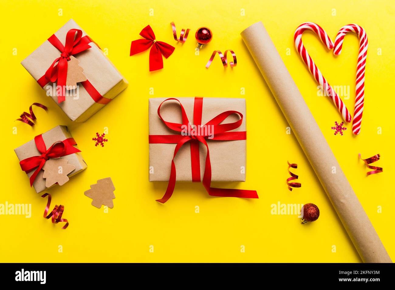 Christmas kraft gifts box with ribbon on colored background. Cozy ...