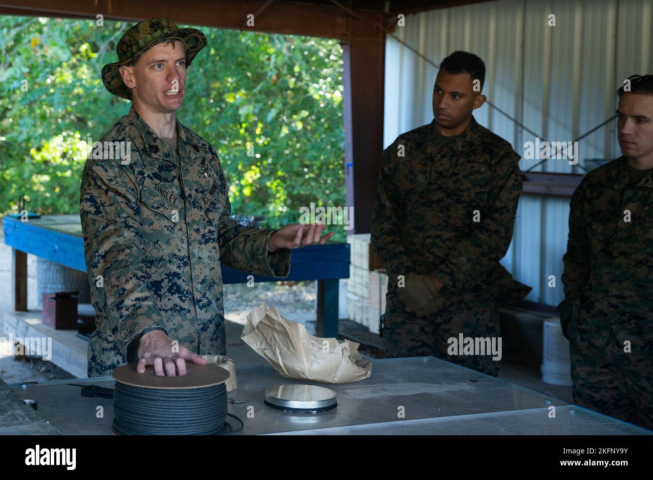 U.S. Marine Corps Staff Sgt. Dylan Tinsley, left, an Explosive Ordnance ...