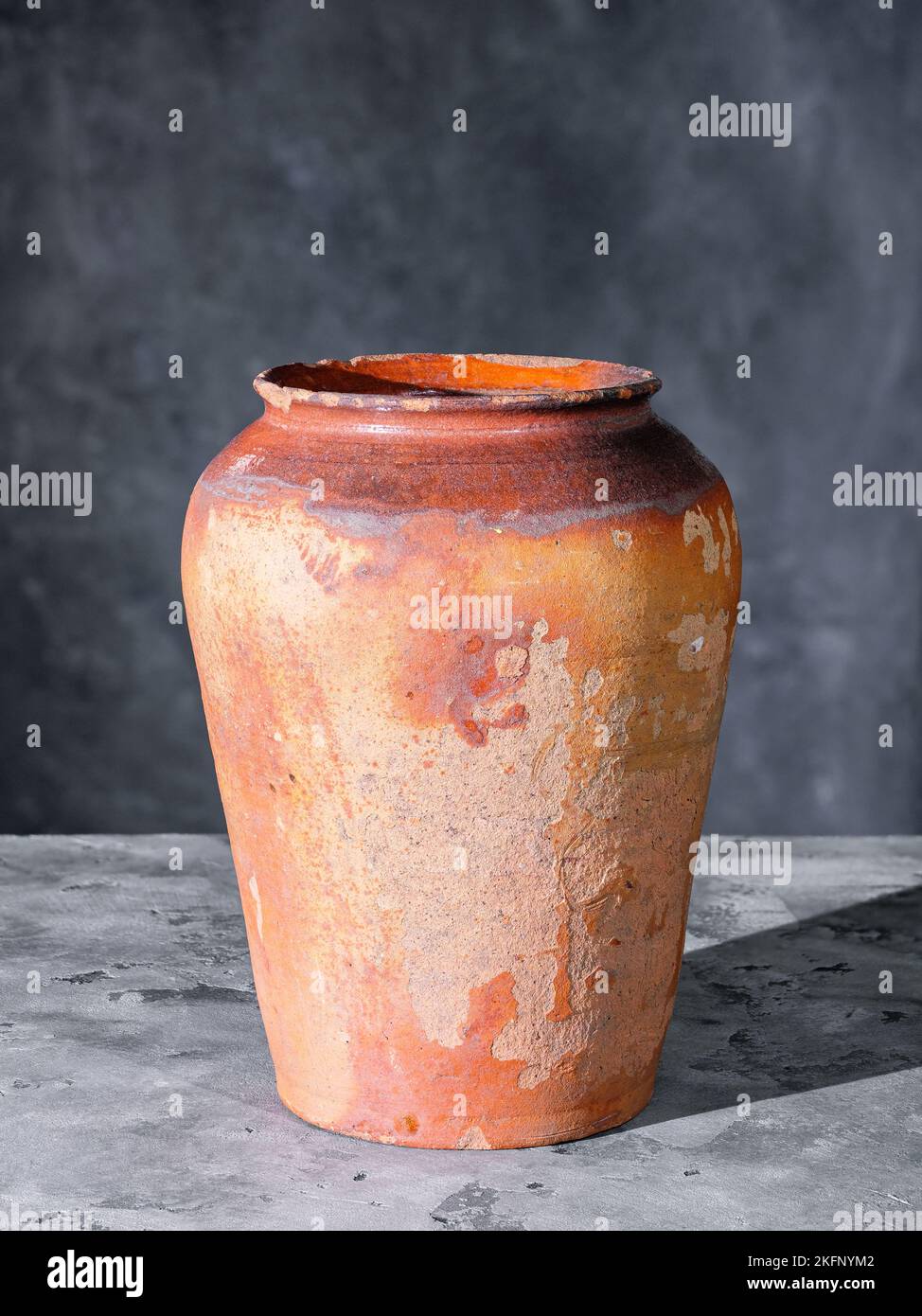 Old shabby ceramic jug on a gray concrete surface Stock Photo - Alamy