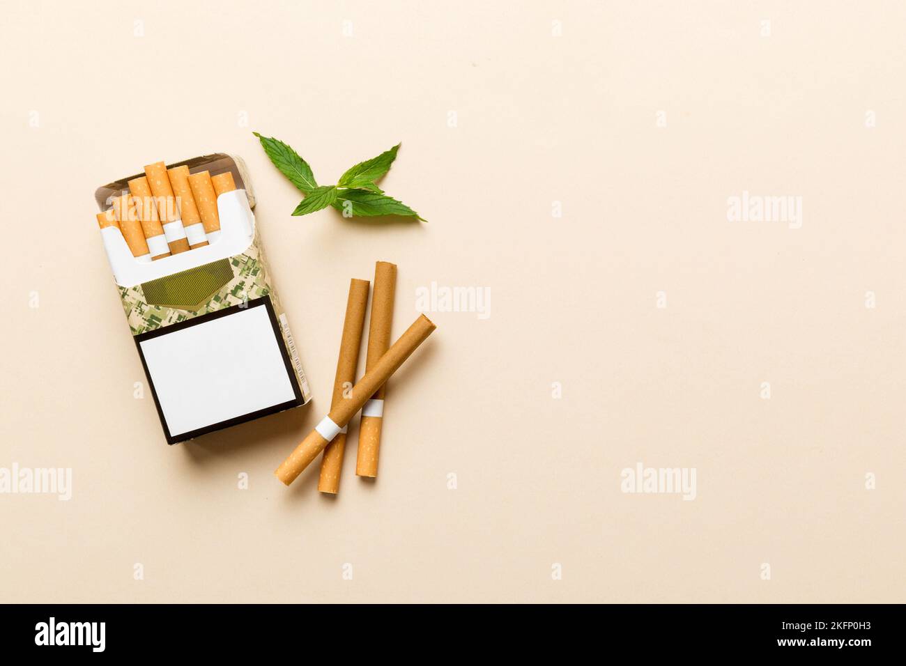 Pack of menthol cigarettes and fresh mint on colored table, Menthol ...