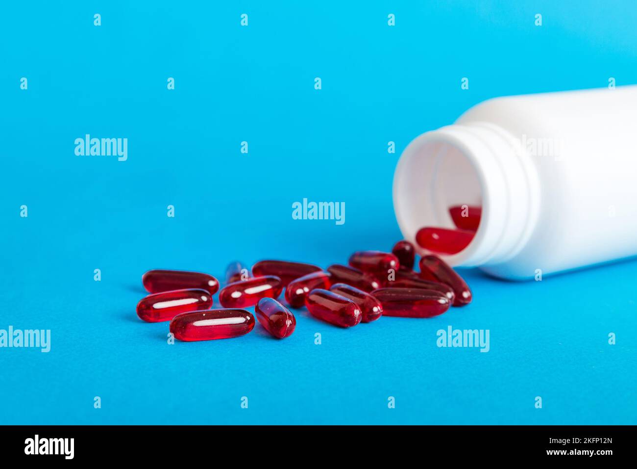 Red pills spilled around a pill bottle. Medicines and prescription ...