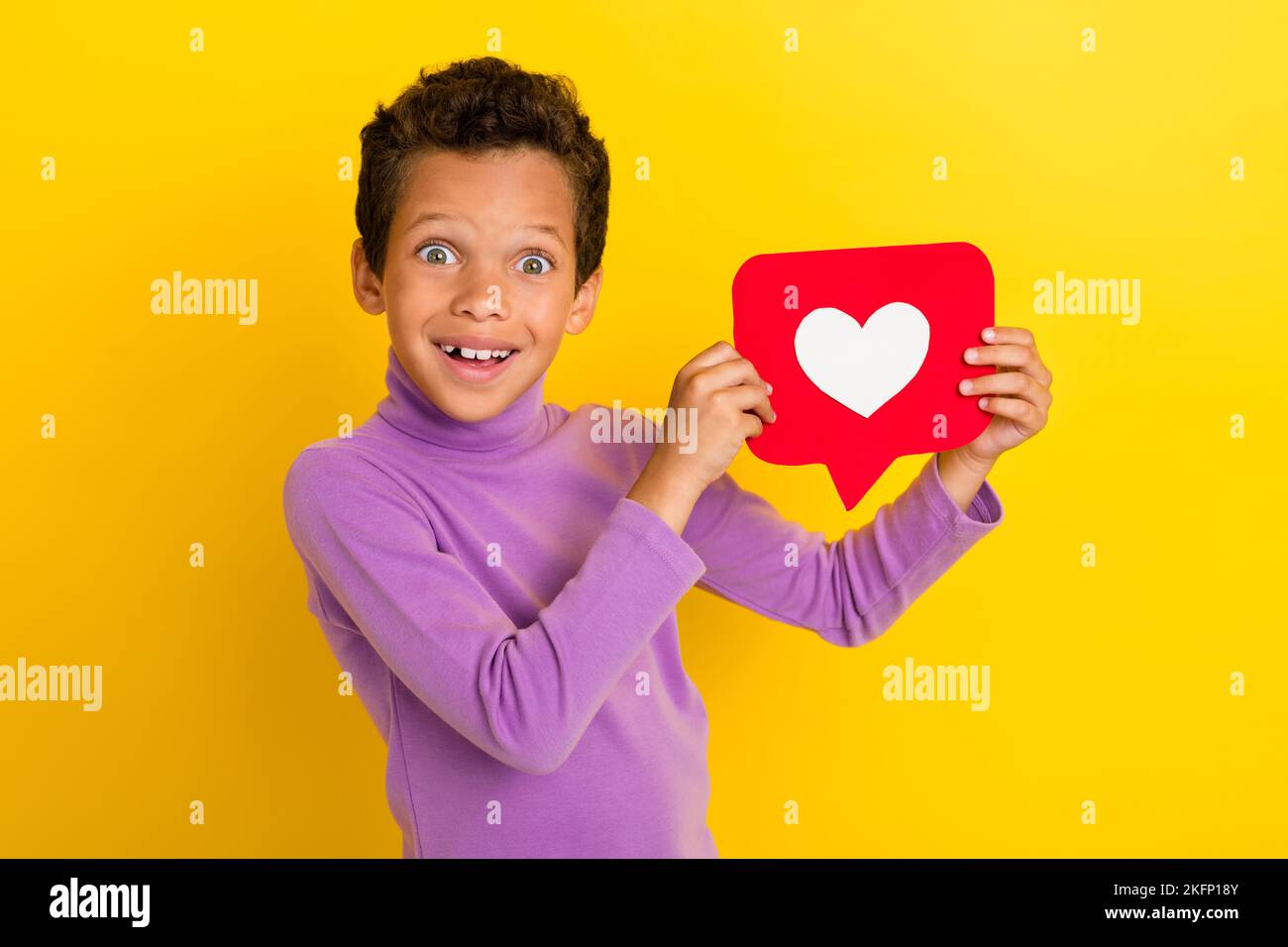 Portrait of funny astonished boy arms hold paper like card beaming ...