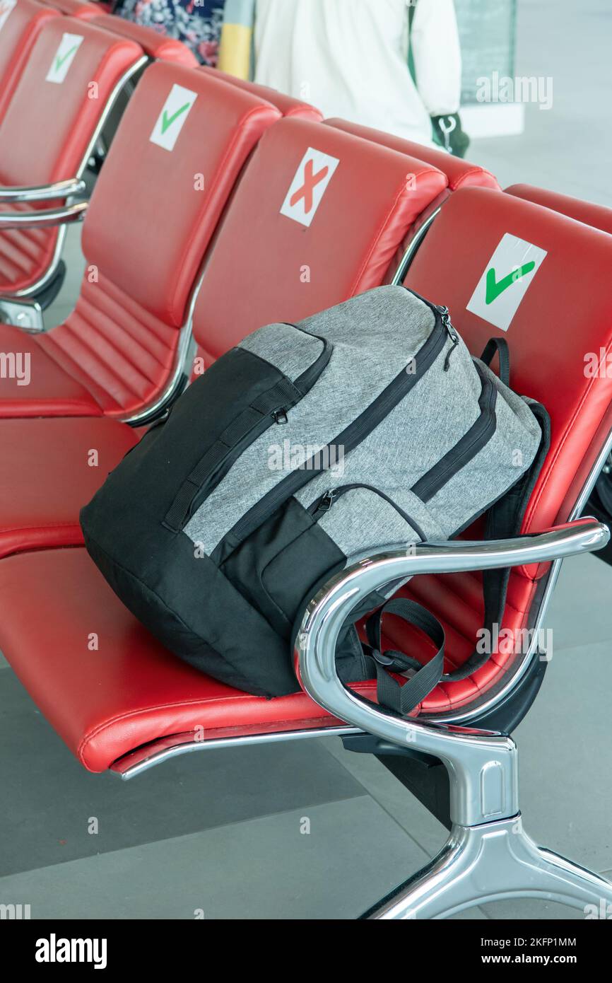 A lonely backpack at the airport in the waiting room. Forgotten luggage ...
