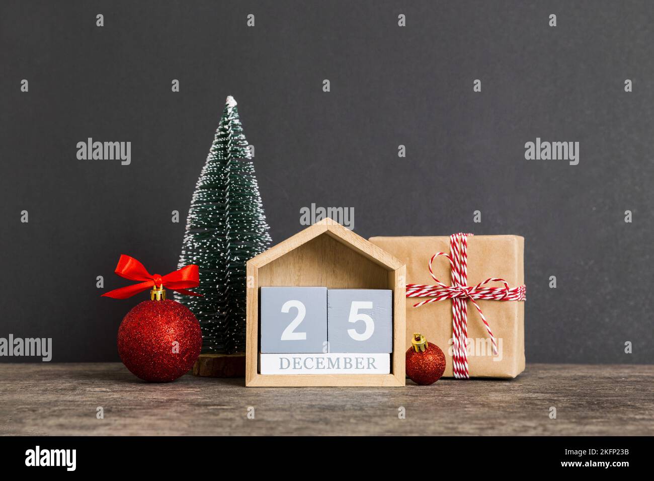 25 december. Christmas composition on colored background with a wooden ...