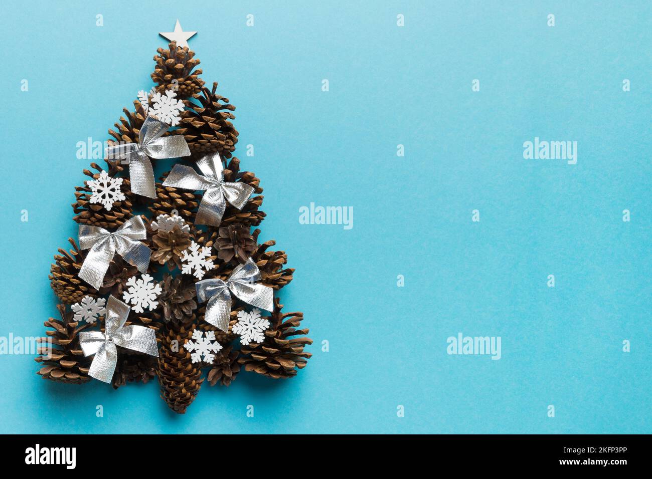 Christmas tree made from natural cones on colored background, view from ...