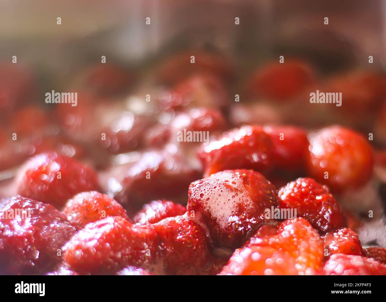 Strawberry jam oreparing process. Berries are boiled in a saucepan ...