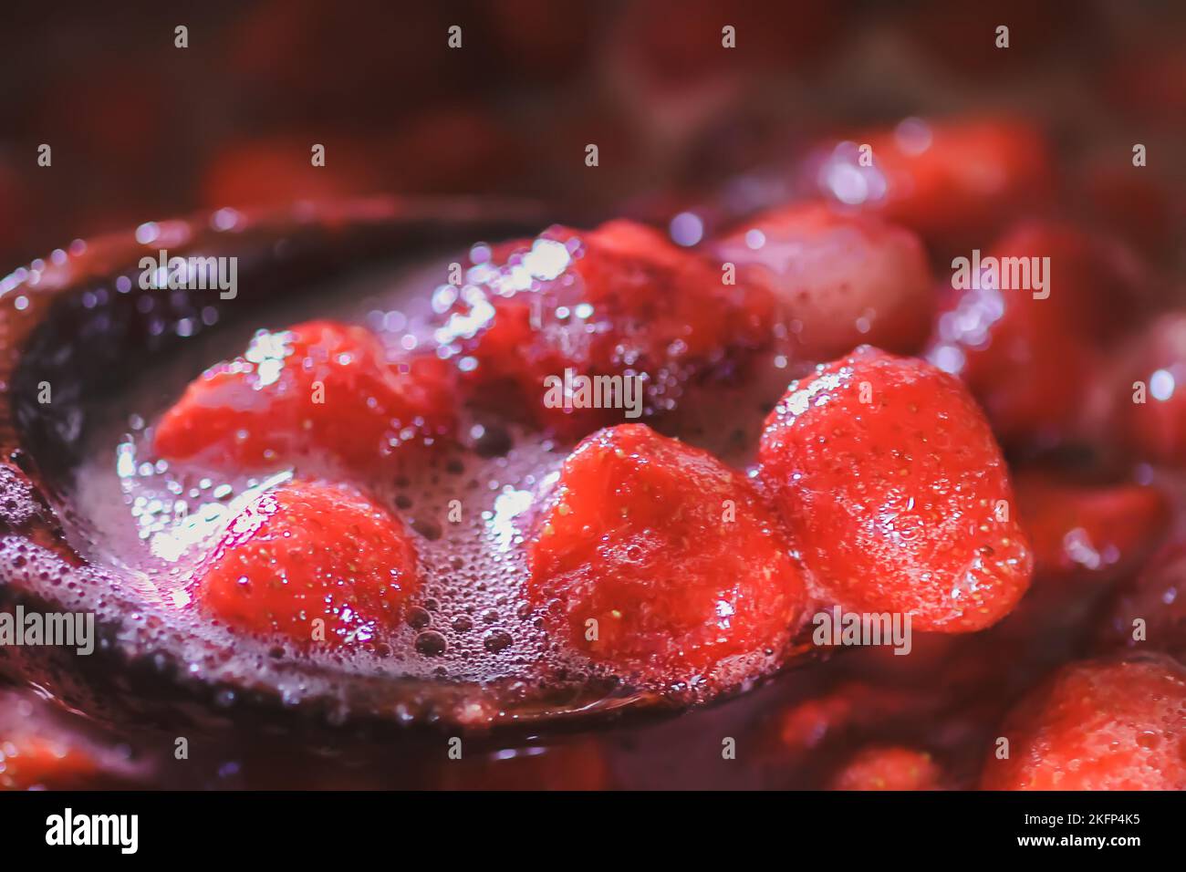 Strawberry jam oreparing process. Berries are boiled in a saucepan ...