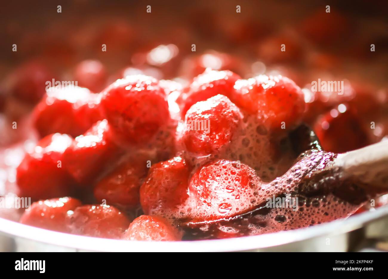 Strawberry jam oreparing process. Berries are boiled in a saucepan ...