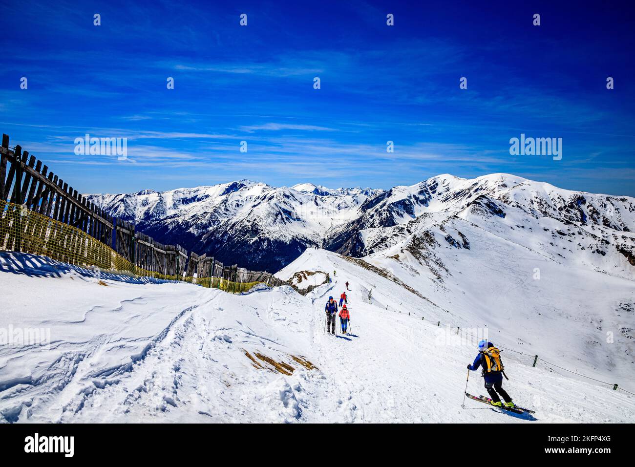 Winter scene with hikers and skiers on snowy mountain slopes Stock ...