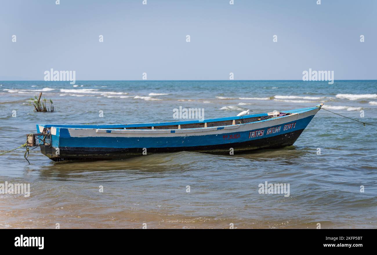 Fishing boat on the shore of lake Malawi (little Egret perced on side ...