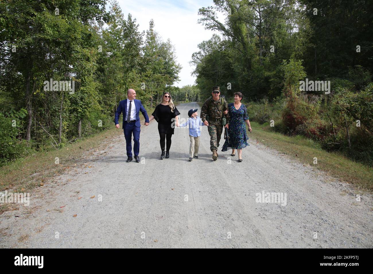Col. Kirk D. Mullins is pictured above walking alongside his family ...