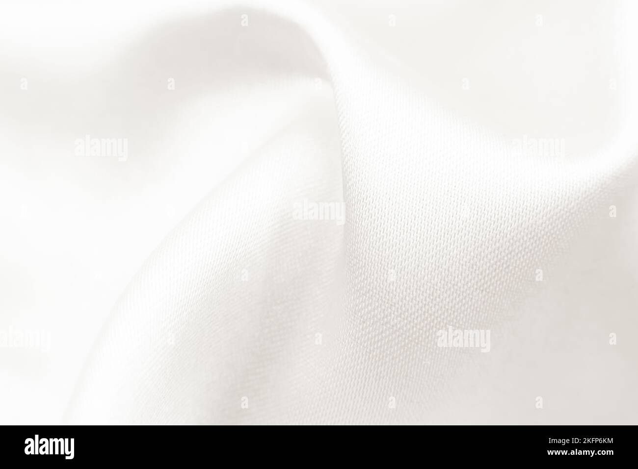 The texture of a fabric made of silk or calico with waves and rumples ...