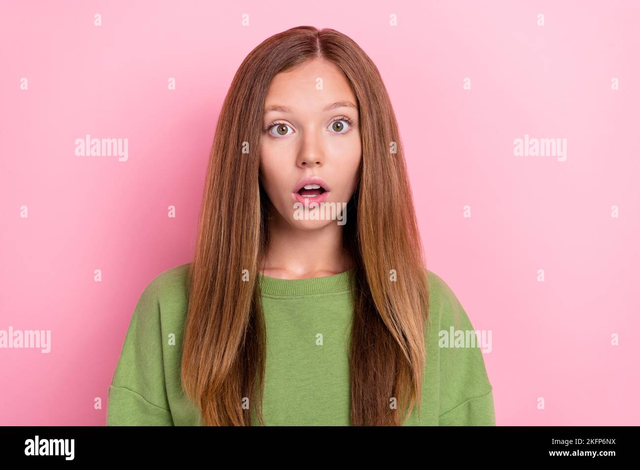 Portrait of astonished cute girl with long hairdo dressed green ...