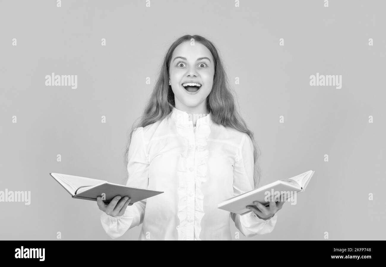 surprised teen girl ready to study do homework with book on yellow ...