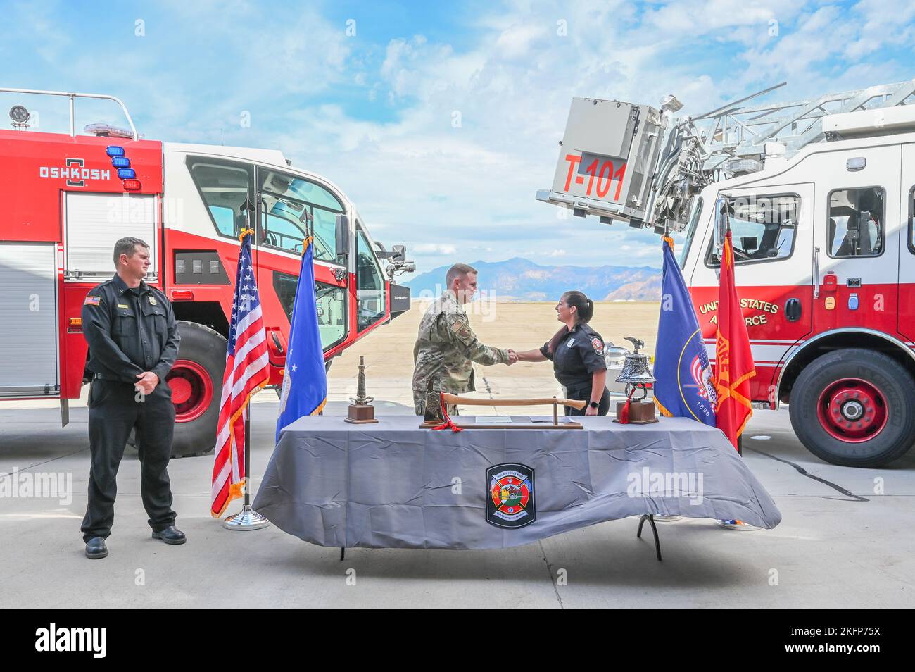 Col. Jeffrey Holland, 75th Air Base Wing commander, shakes the hand of ...
