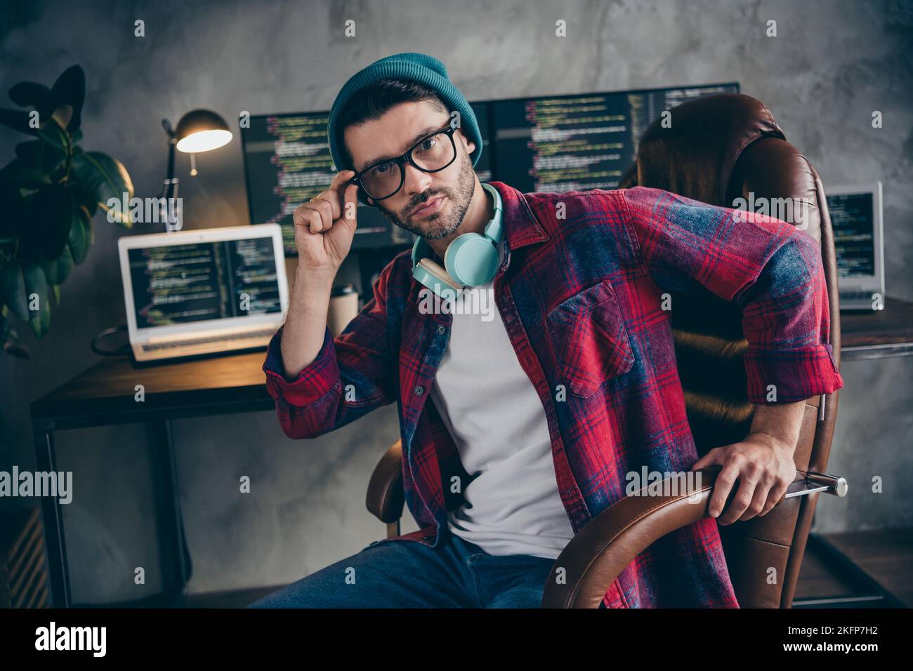 Photo of serious confident programmer wear earphones writing music ...