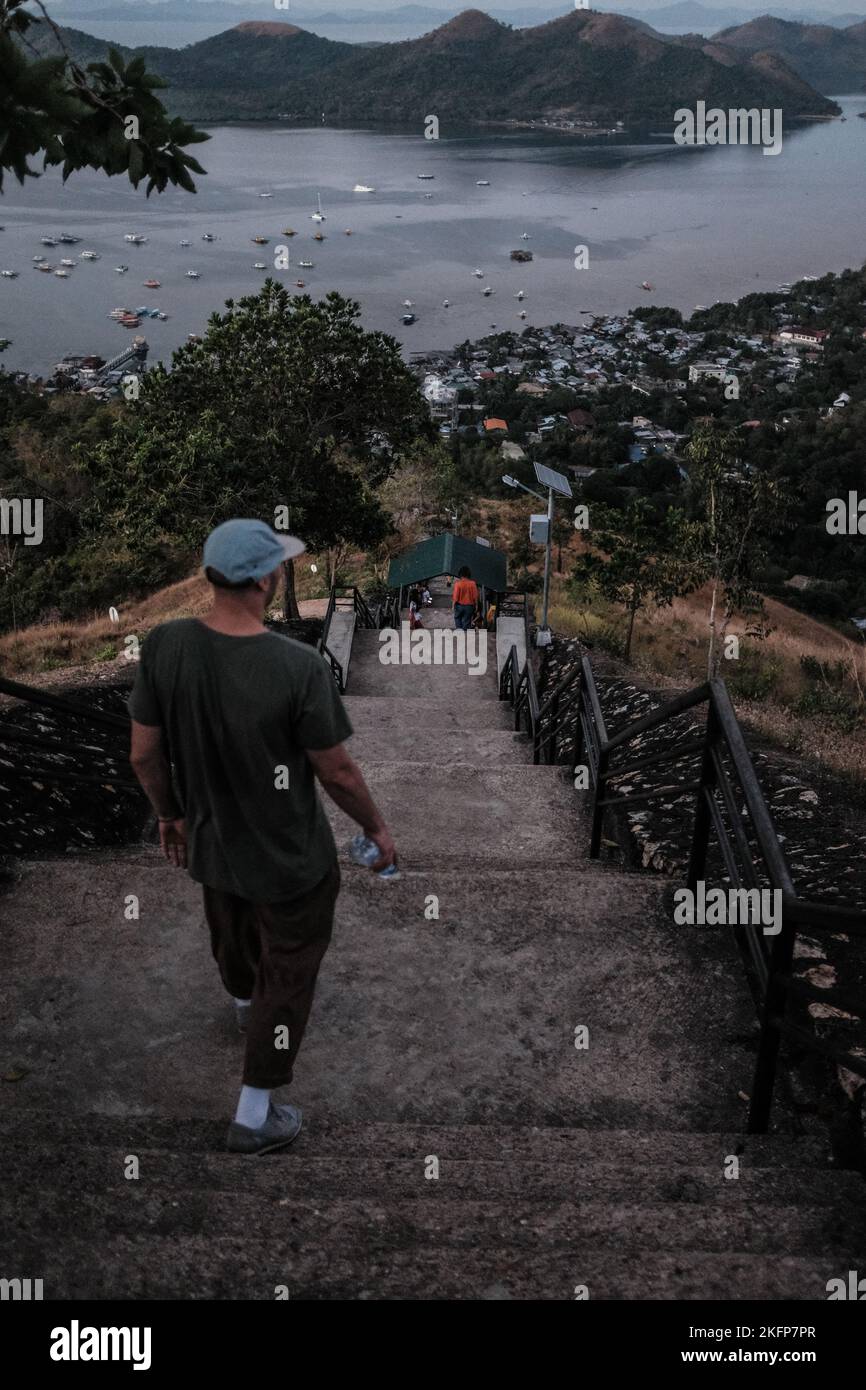 A vertical shot of a man walking down the stairs of Mount Tapyas in ...